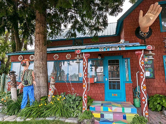 A giant waving hand and a life-size figure greet you at 101 N Pearl Street like old friends.