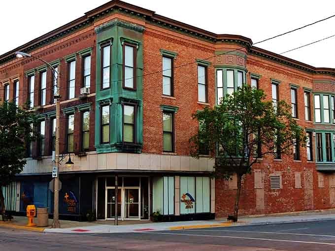 Green-trimmed windows on red brick create the kind of architectural charm developers can't replicate no matter how hard they try.
