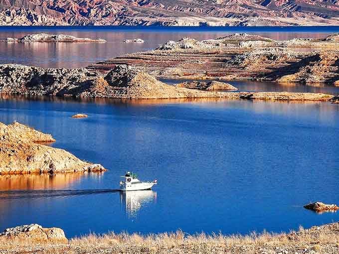 One lone boat, endless blue water, and striped canyon walls — Lake Mead delivers pure drama.