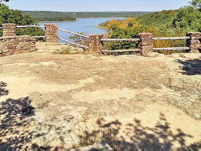 Sun-baked rock, dappled shadows, and a lake curving through autumn trees &mdash; this overlook earns every uphill step.