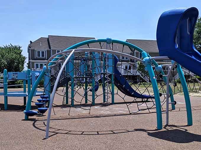 Modern equipment in cheerful teal colors pops against the waterfront sky, making this seaside spot absolutely irresistible for families.