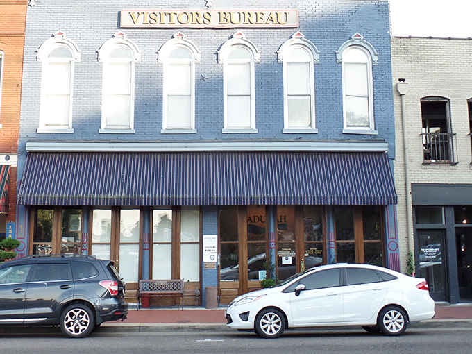 That classic Visitors Bureau building stands ready to point you toward your next unforgettable meal in this riverside gem.