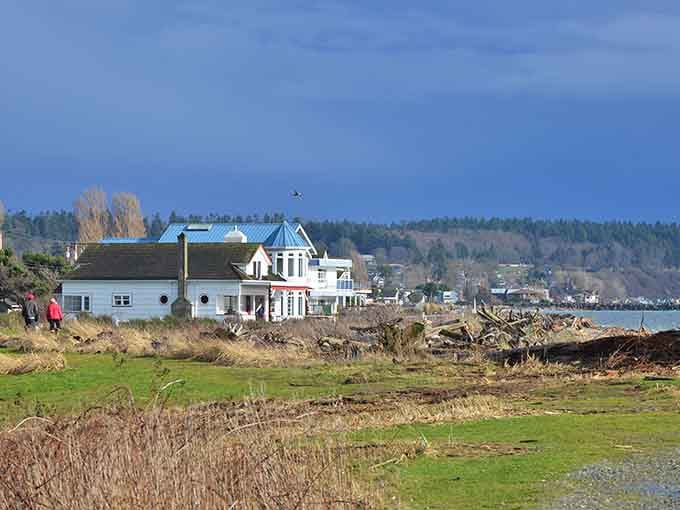 The rugged shoreline and distant mountains create a stunning backdrop for this quiet seaside neighborhood.