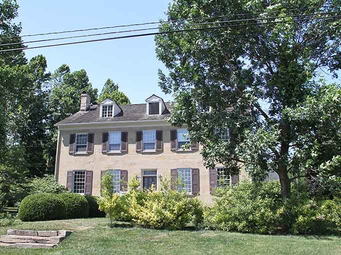 This stately stone home, half-hidden by leafy trees, looks like it has been quietly watching Sainte Genevieve's history unfold from the very beginning.