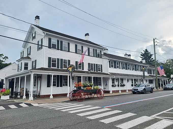 Two American flags, a covered porch, and fresh flowers tell you everything about this Essex treasure.