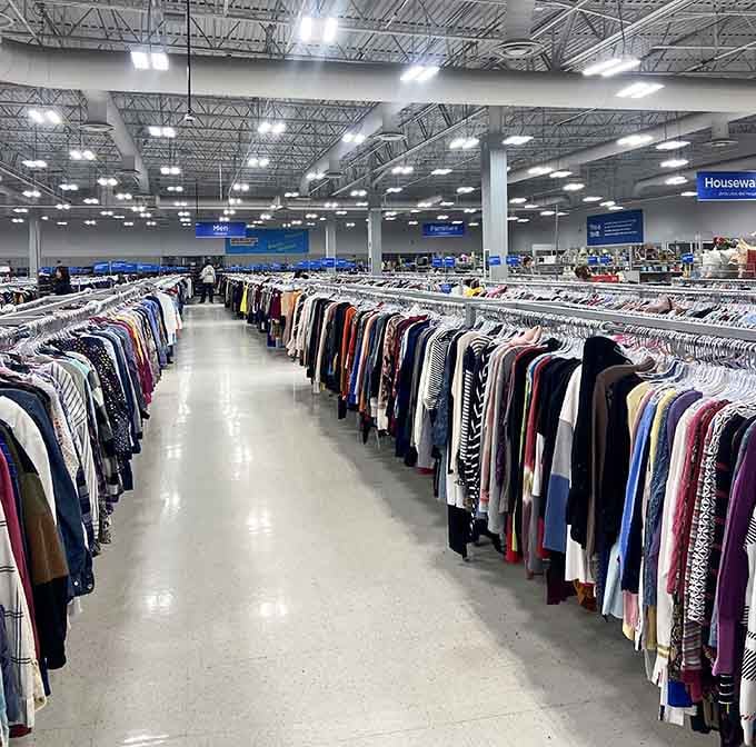 Row after row of colorful clothing stretching into the distance, bright lights overhead, organized sections as far as the eye can see.