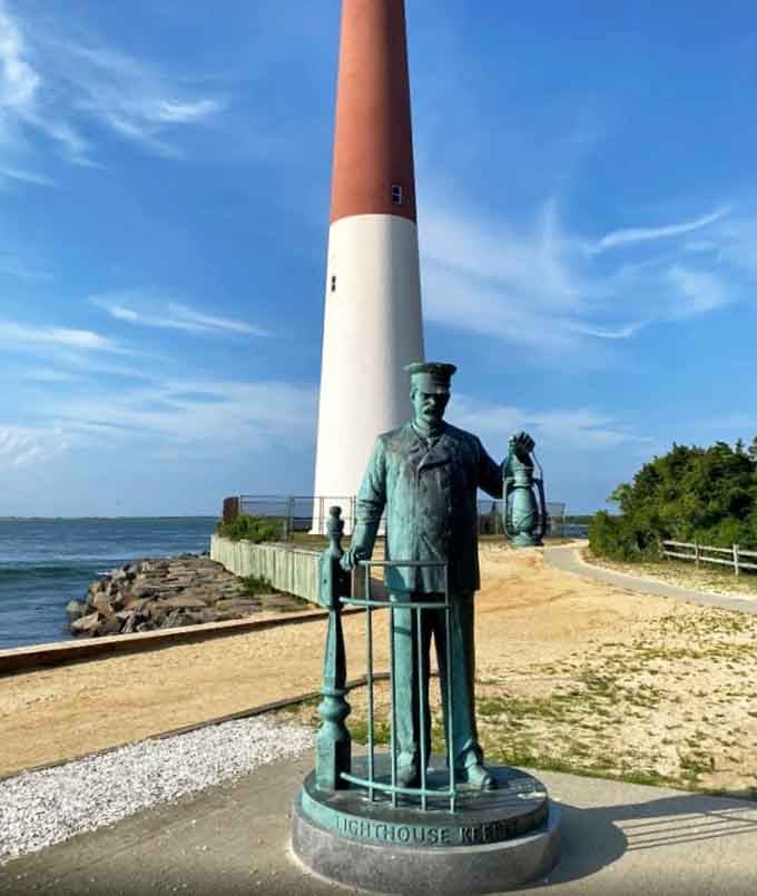 The Lighthouse Keeper statue holds his lantern proudly, a bronze tribute to the unsung heroes who kept sailors safe for generations.