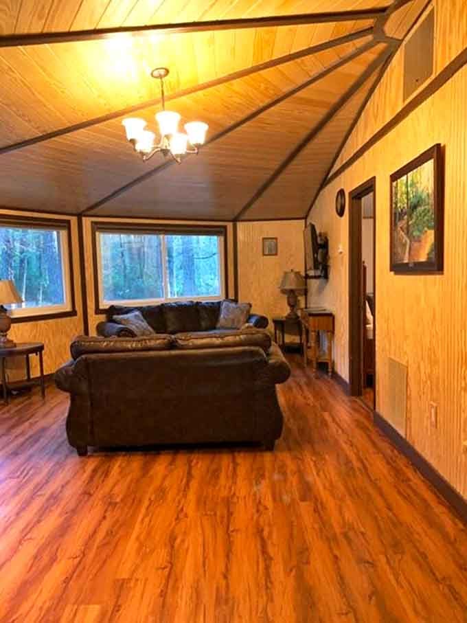 That chandelier, those wood-paneled walls, and warm floors. Somebody clearly decided "rustic" and "comfortable" aren't mutually exclusive.