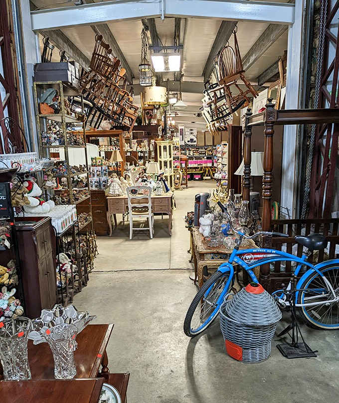 Chairs stacked to the rafters, a blue cruiser bicycle parked mid-aisle, and zero apologies about it.