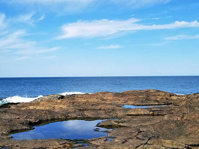 Low tide reveals a rocky wonderland at Brant Rock, nature's own obstacle course built for curious explorers.