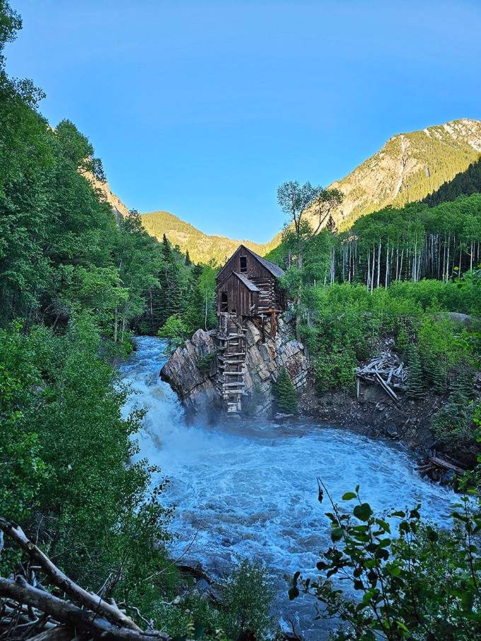 Water rushes beneath timbers that have somehow survived more than a century of Colorado's mood swings.