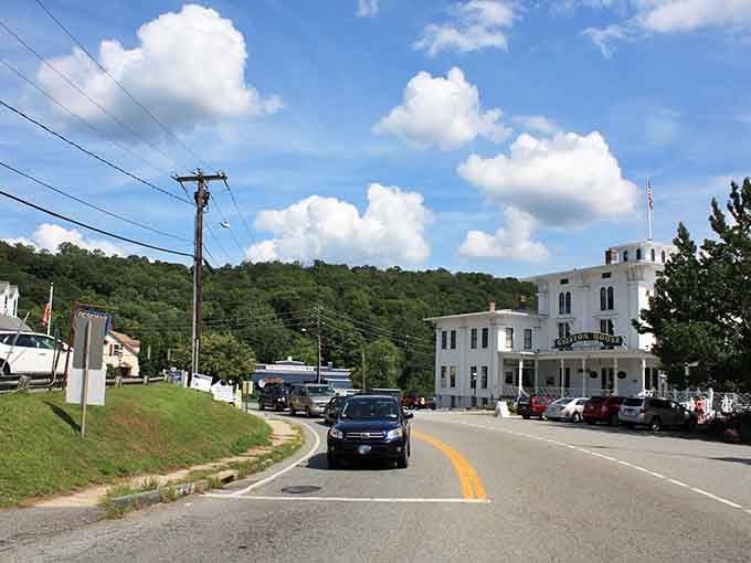 Cruising past historic buildings on the town's main street under a beautiful, bright blue sky.