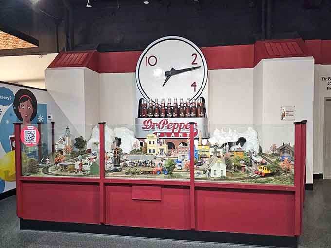This charming miniature bottling plant display, complete with the iconic 10-2-4 clock, proves tiny things tell the biggest stories.