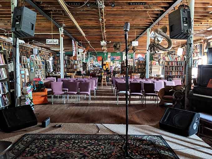 Books lining every wall, purple chairs waiting patiently, and a microphone ready for whoever has something worth saying.
