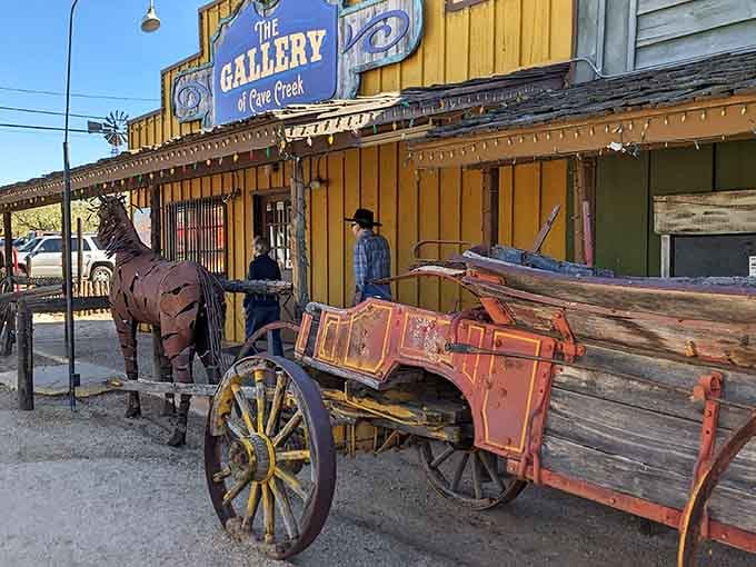 A rusted metal horse and a battered old wagon outside the Gallery of Cave Creek &mdash; art meets history beautifully.