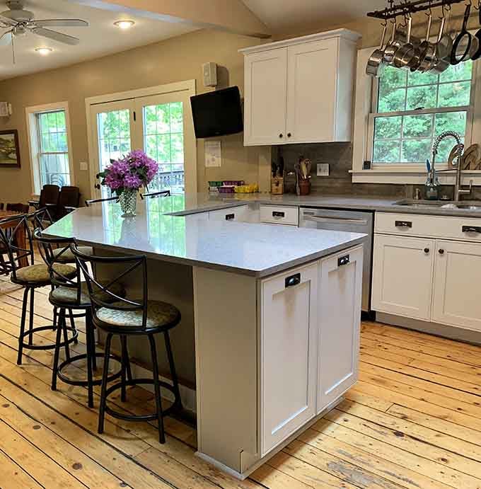 Pine floors, hanging pots, and a kitchen island that quietly dares you to cook something magnificent.