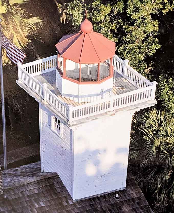 That red-roofed lantern room and wraparound railing are basically begging you to stand up there dramatically in the wind.