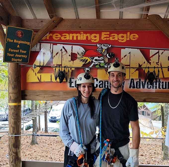 Two adventurers suited up and smiling at the Screaming Eagle entrance, ready to earn their wings.