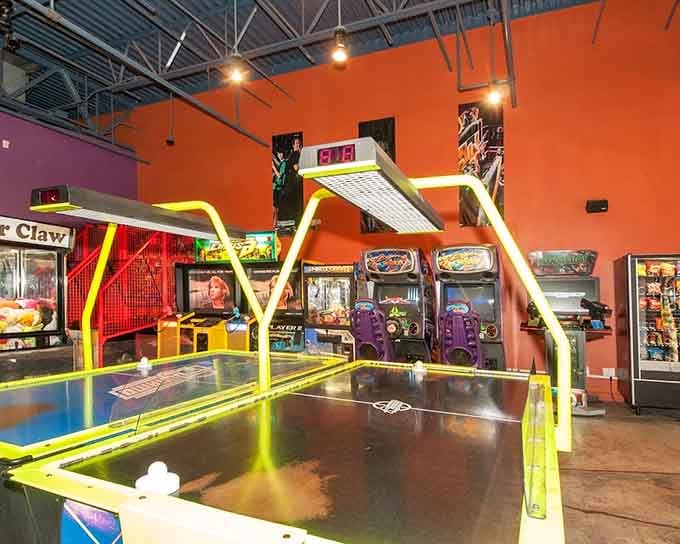 Neon-trimmed air hockey tables gleaming under bright lights, proof that the classics never really go out of style.