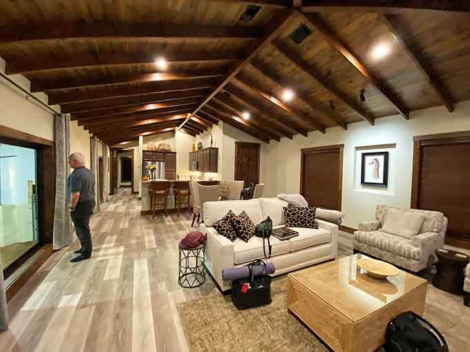 Exposed wooden beam ceilings and giraffe-print pillows make this living space the coziest barn-adjacent room you'll ever love.