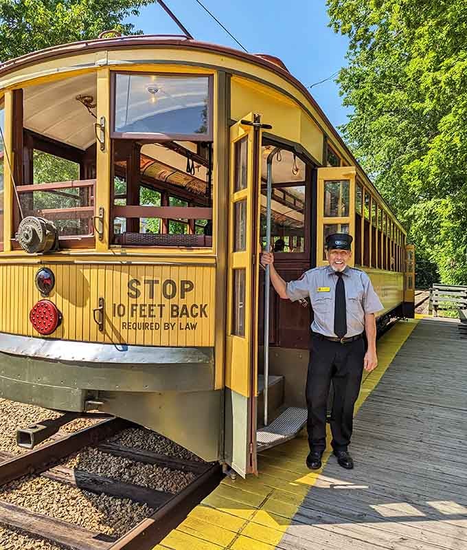 A smiling conductor holding the door open is basically the universe saying, "Yes, this is a great idea."