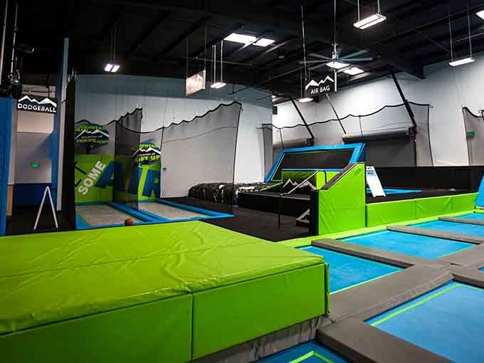 Bright blue and lime green trampolines stretch out like a bouncy wonderland designed by someone who really understood childhood.