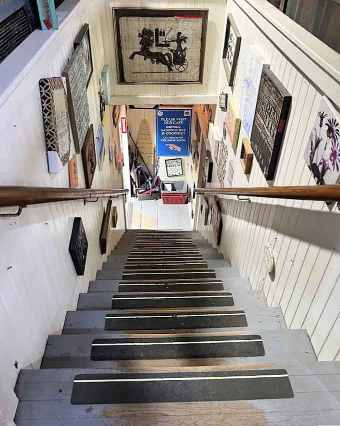 Every step down this art-lined staircase feels like flipping through a gallery you never knew existed inside a thrift store.