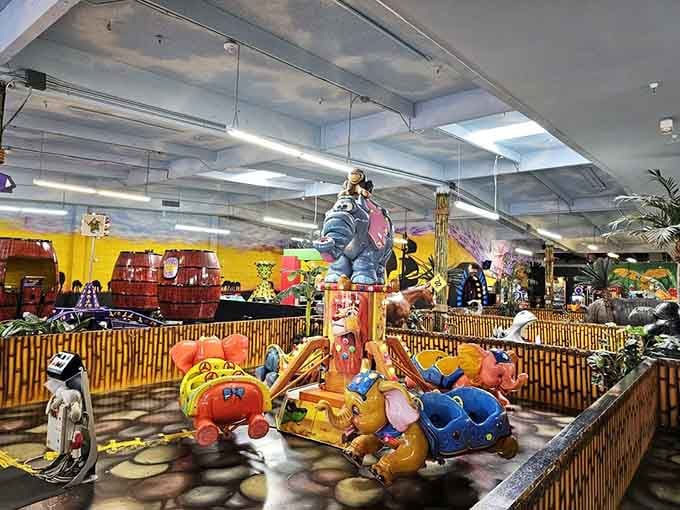 Colorful elephant cars mid-spin, monkey perched on top. This ride delivers pure, unfiltered childhood joy.