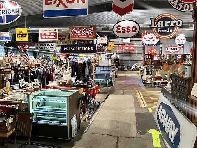 Vintage Esso, Texaco, and Coca-Cola signs hang overhead like a greatest hits album of American roadside culture.