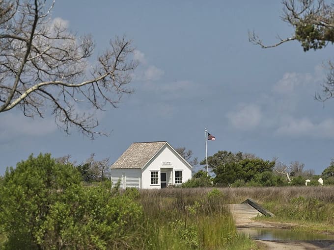 That little white post office still flies the flag proudly, like it's expecting mail any day now.