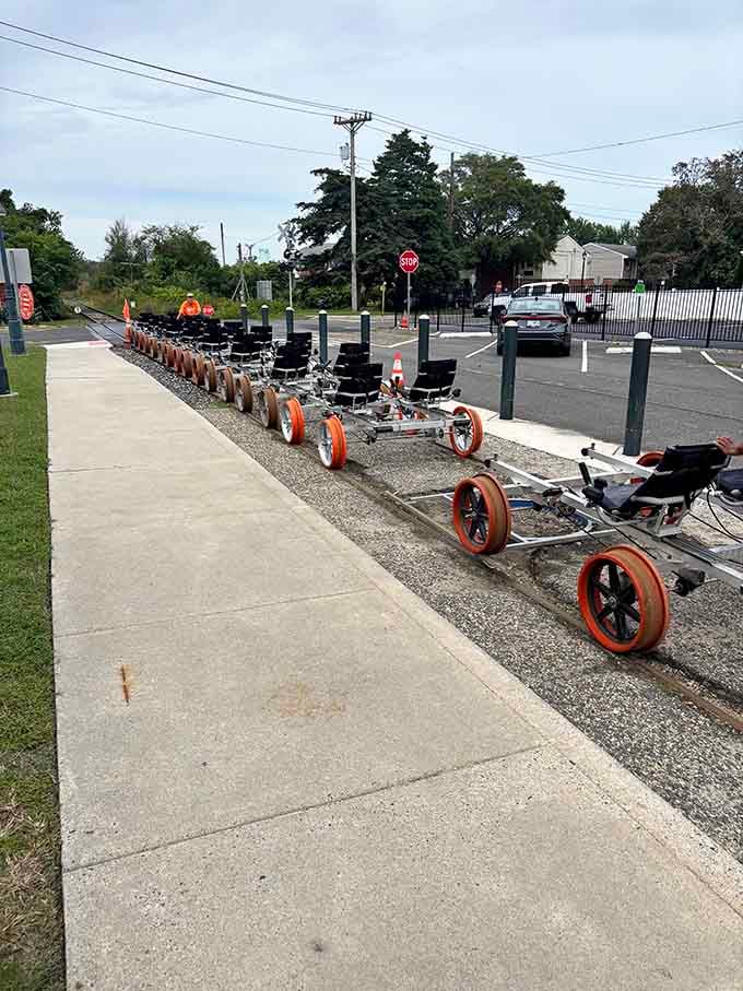 A fleet of orange-wheeled rail bikes lined up and ready, like the world's most interesting parking lot.