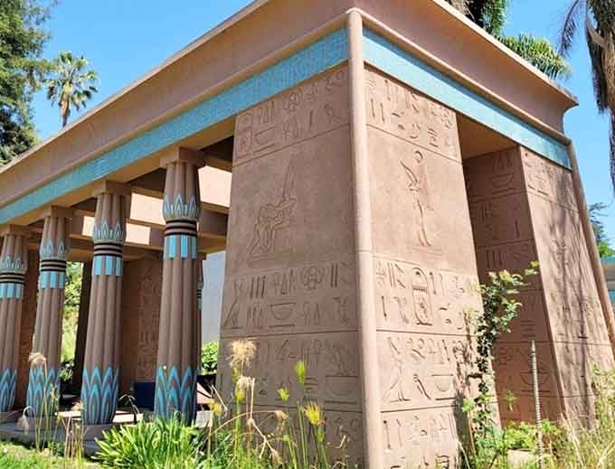 Hieroglyphics carved into terracotta walls and turquoise lotus columns, because some architecture simply refuses to be ignored.
