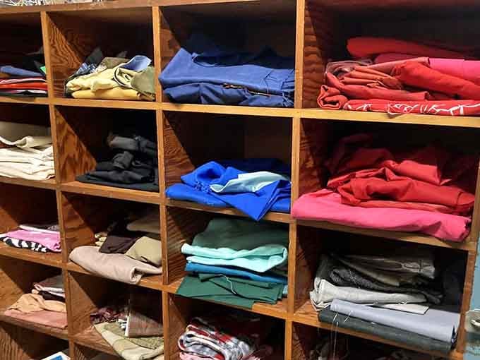 Color-coded clothing stacks create a rainbow that would make Marie Kondo smile with organizational joy.