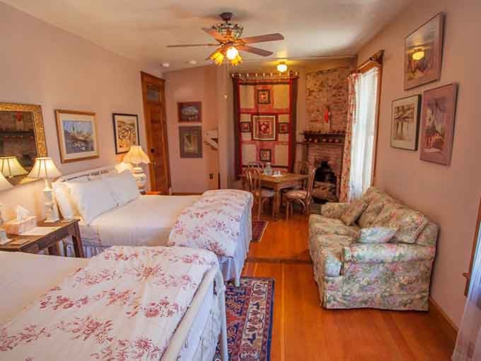 Floral bedding, a crackling fireplace, and a floral armchair that clearly has no intention of letting you leave anytime soon.