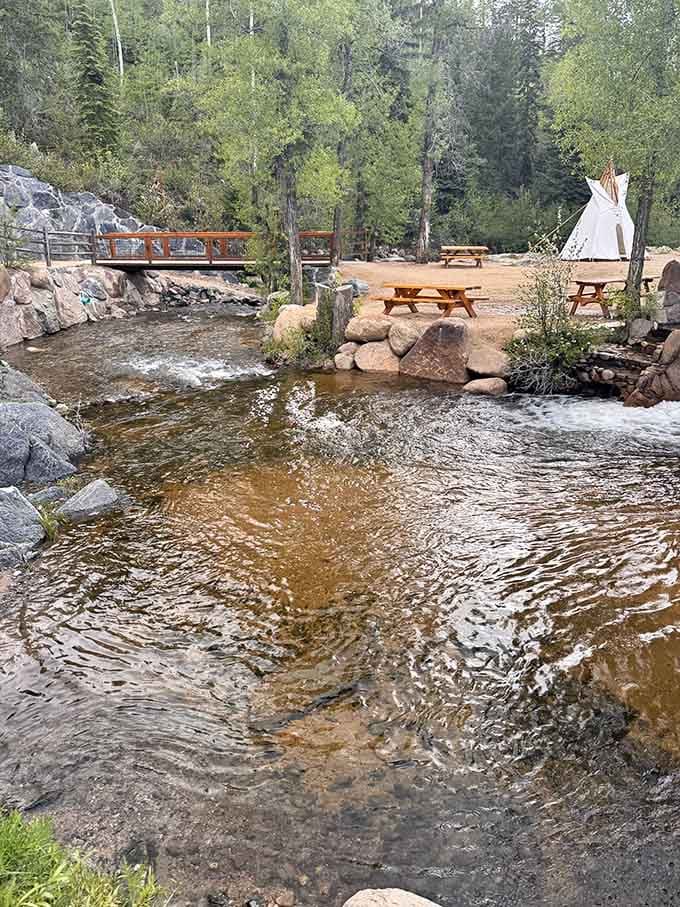 Hot water meets cold creek right here, with picnic tables and a teepee standing by like the world's most relaxed welcoming committee.