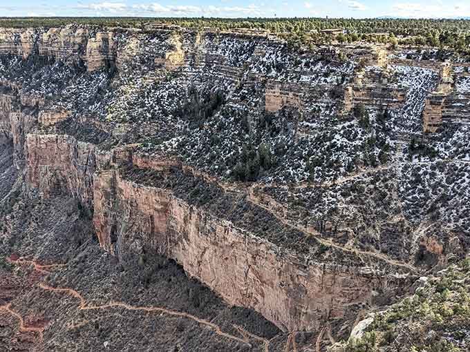 Snow dusts the canyon walls like powdered sugar on the world's most dramatic dessert you never ordered but absolutely needed.