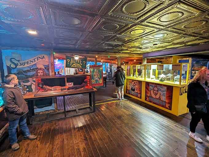 Vintage sideshow banners and pressed tin ceilings create a carnival atmosphere that feels genuinely rare and wonderful.