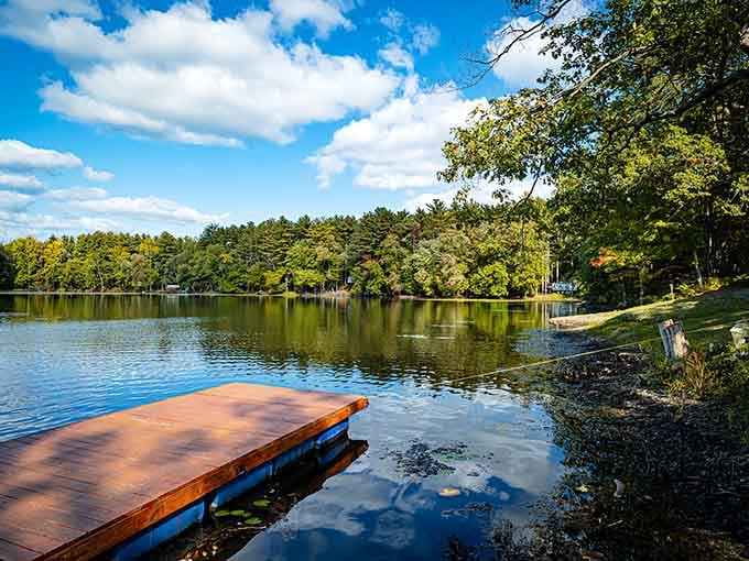 That dock stretches into mirror-perfect water, practically begging you to cannonball into your best summer memories.
