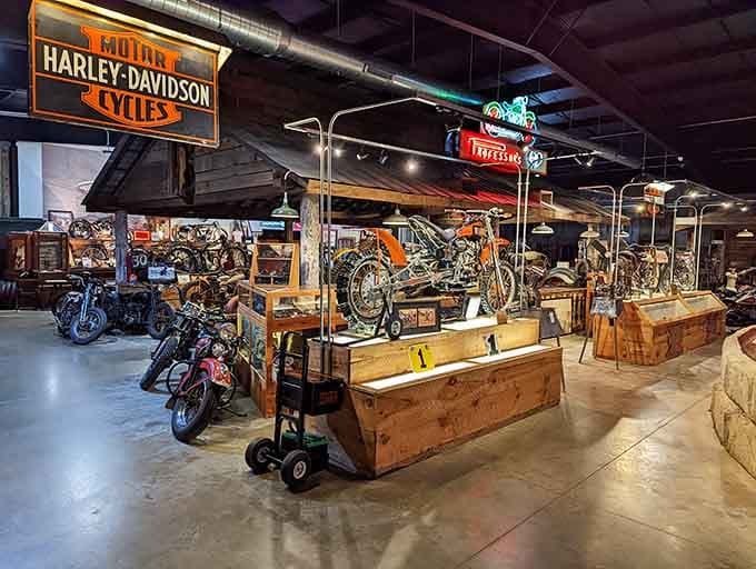 A glowing Harley-Davidson sign presides over wooden display platforms like a proud grandfather at a family reunion.