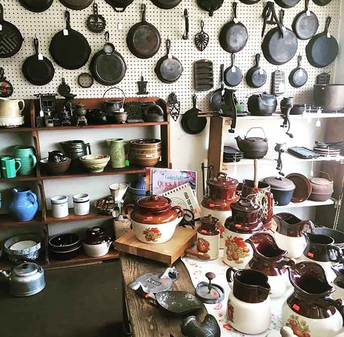 An entire wall of cast iron skillets, because apparently some people take their cookware very, very seriously.