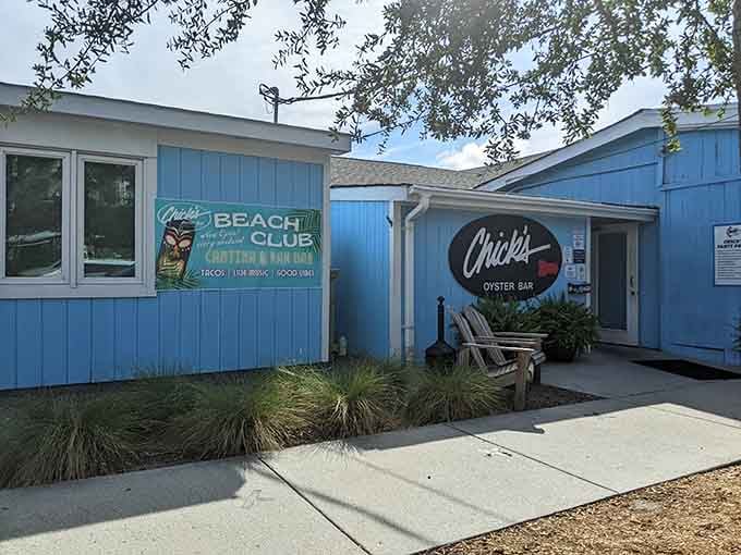 Two Adirondack chairs, a Beach Club sign, and a bright blue building: Chick's Oyster Bar is already winning.