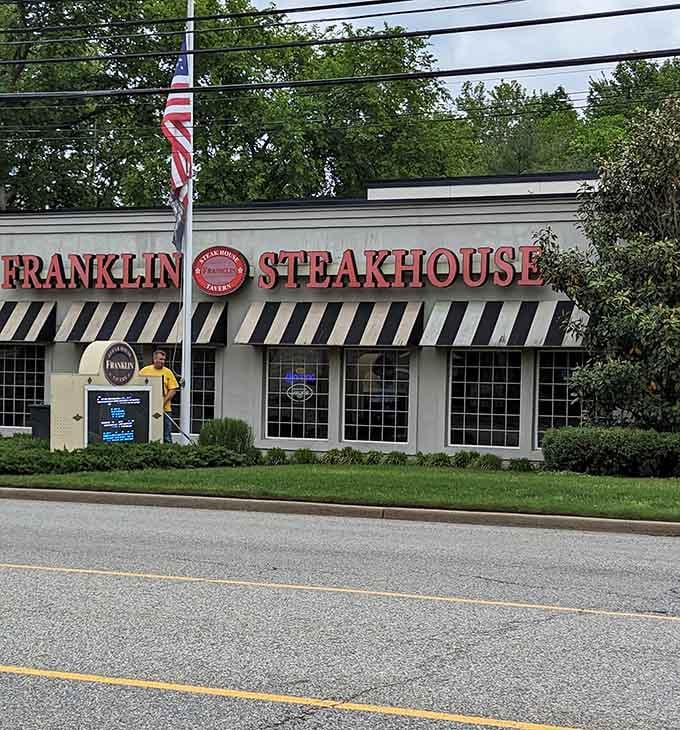 Bold red letters, a crisp American flag, and striped awnings — Franklin Steakhouse announces itself without whispering.