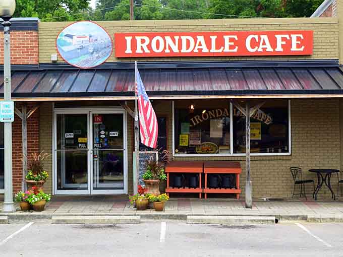 Flower boxes, a waving flag, and a bold red sign: Irondale Cafe wears its charm proudly.