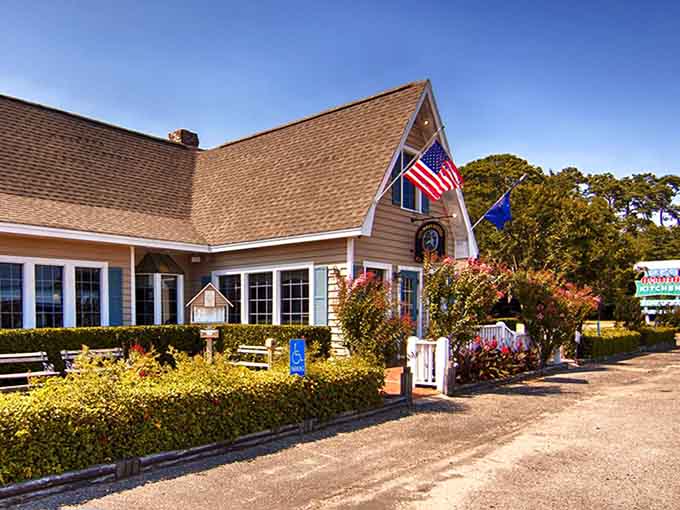 Blooming crepe myrtles and a tidy white picket gate make this coastal cottage look like a seafood fairy tale.