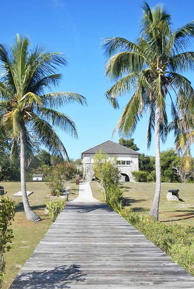 Two palm trees, a coral rock house, and a wooden boardwalk that practically dares you to explore what's waiting at the end.