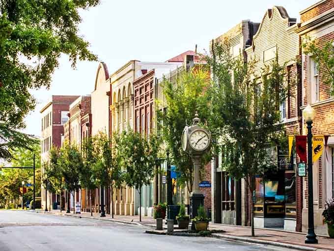 Tree-lined streets and that classic street clock make window shopping feel like an actual event here.