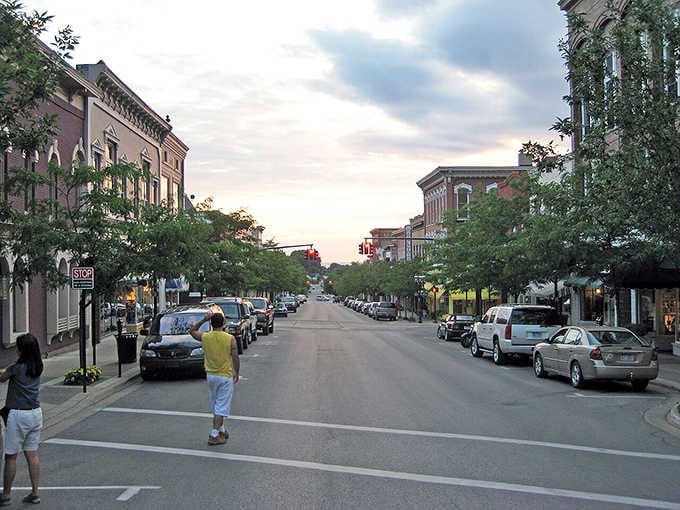 Petoskey's Gaslight District glows warmly at dusk, its tree-lined streets and classic brick buildings whispering, "Stay a little longer, you deserve it."
