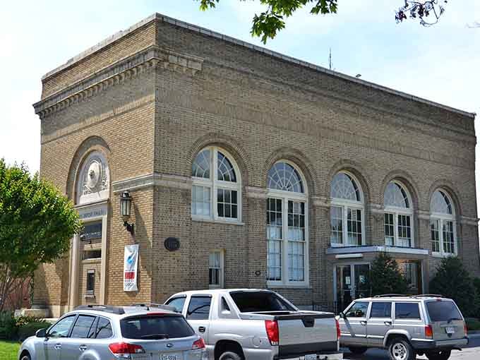 Admire the beautiful, historic brick architecture and large arched windows of this charming downtown building on a bright sunny day.