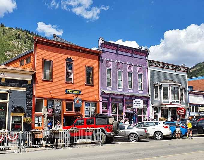 These candy-colored buildings pop against the mountain backdrop like a box of crayons came to life, pure joy.