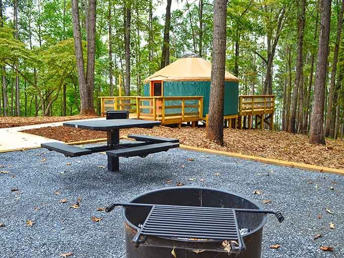 A cozy yurt perched among the trees at Tugaloo, with a fire ring ready and Lake Hartwell just beyond the deck.